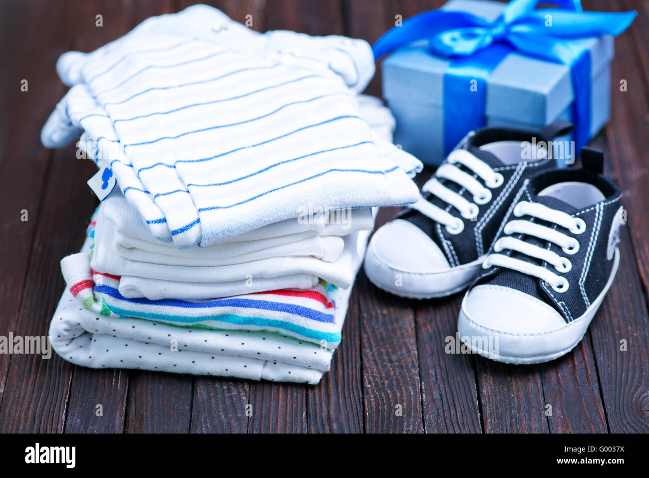 baby clothes and shoes on the wooden table Stock Photo - Alamy