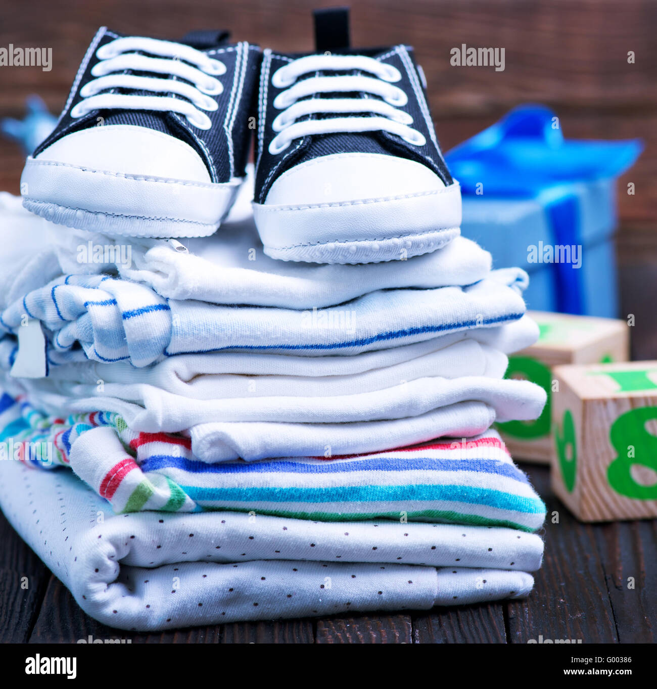 baby clothes and shoes on the wooden table Stock Photo - Alamy