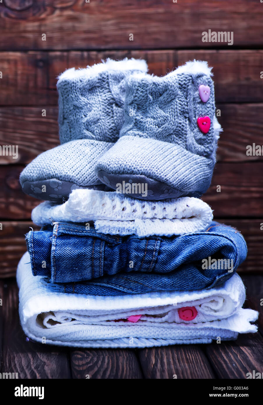 baby clothes and shoes on the wooden table Stock Photo - Alamy