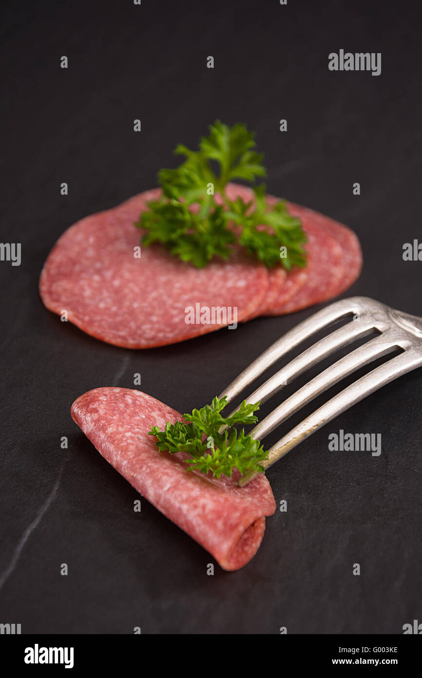 Salami in discs cut Stock Photo - Alamy