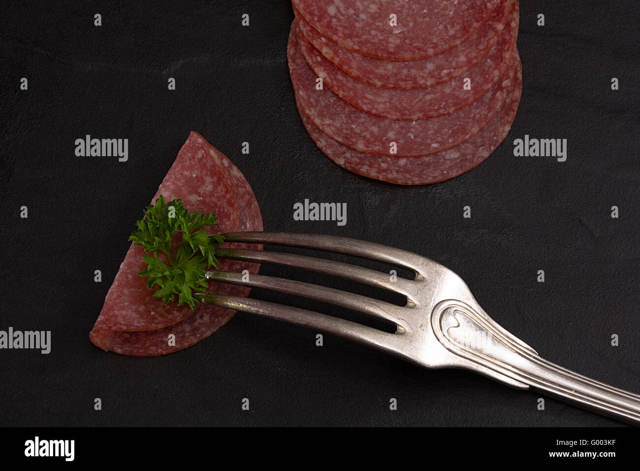 Salami in discs cut Stock Photo - Alamy