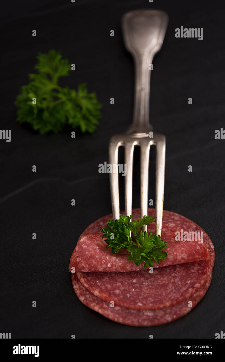 Salami in discs cut Stock Photo - Alamy