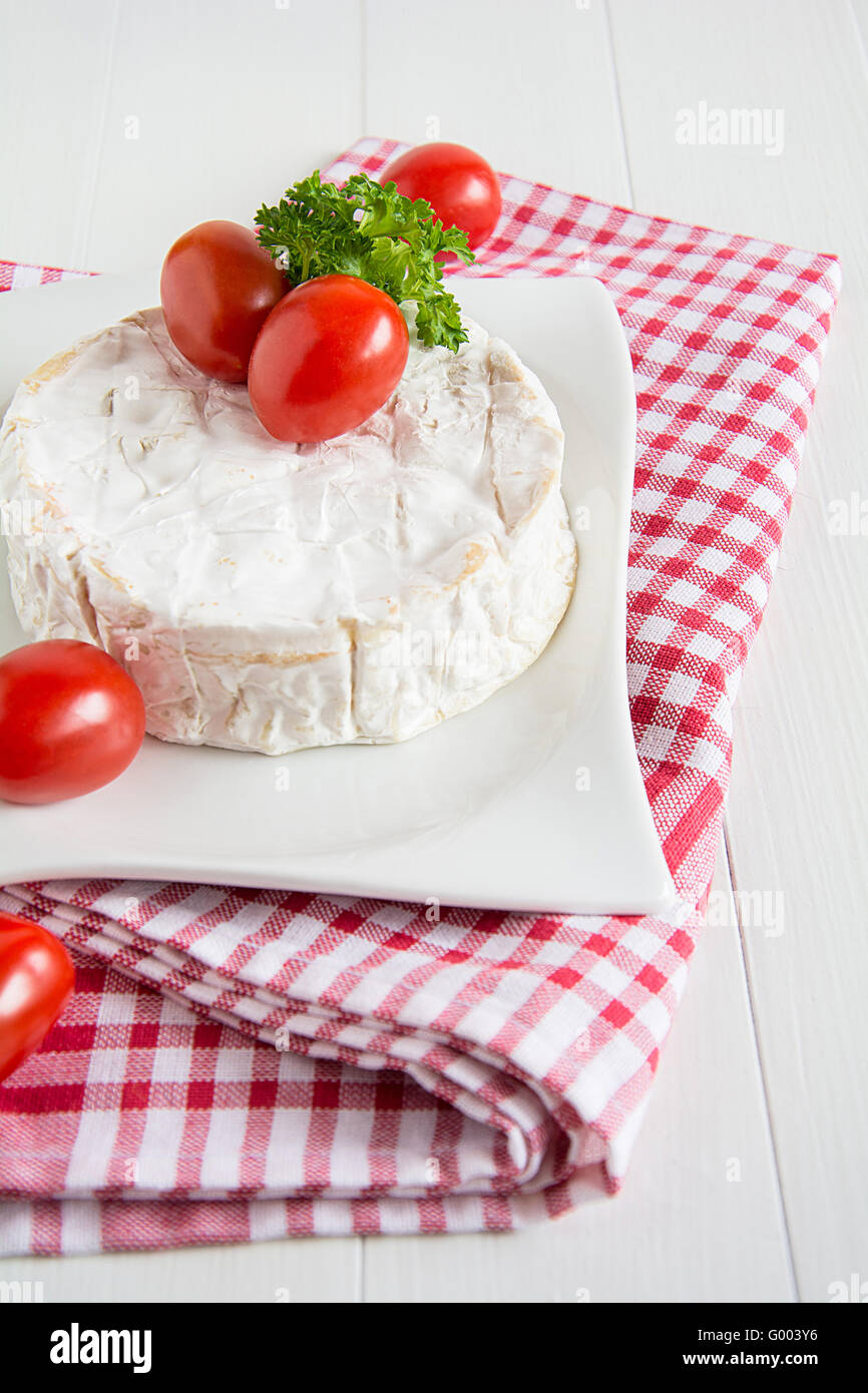 A round Camembert lies on a plate Stock Photo - Alamy