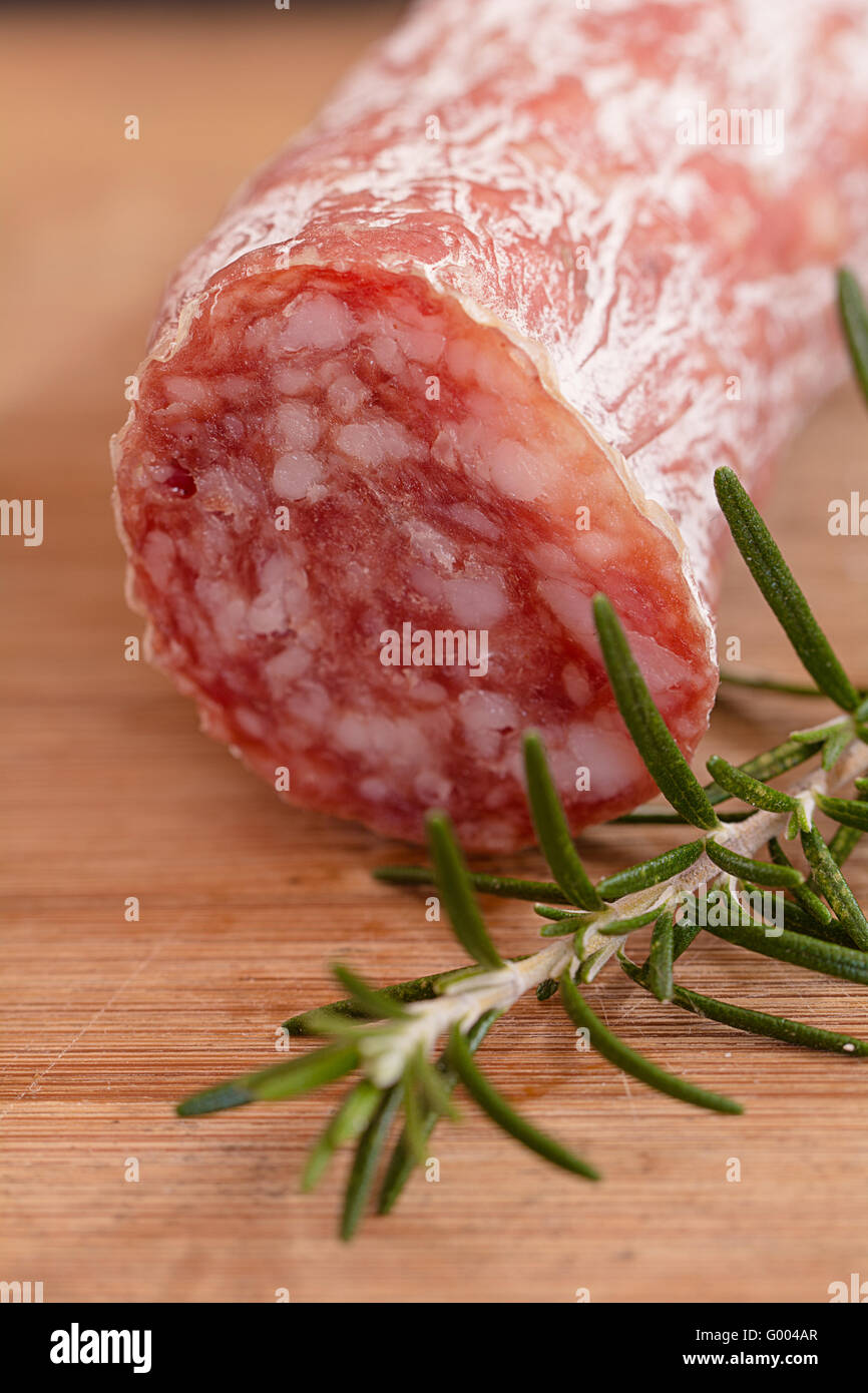 A salami with a branch rosemary Stock Photo - Alamy