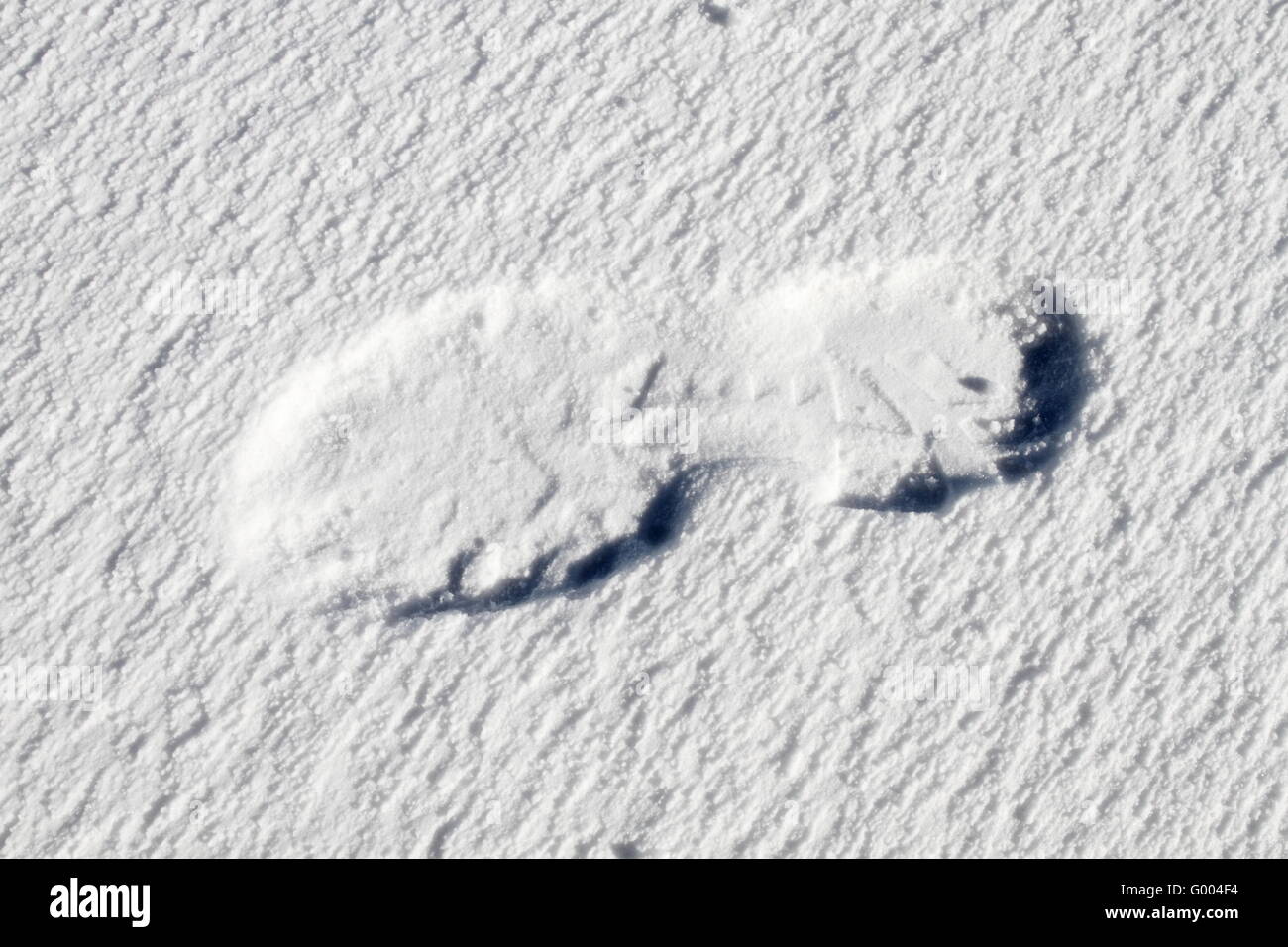 Boot trace on snow background Stock Photo - Alamy