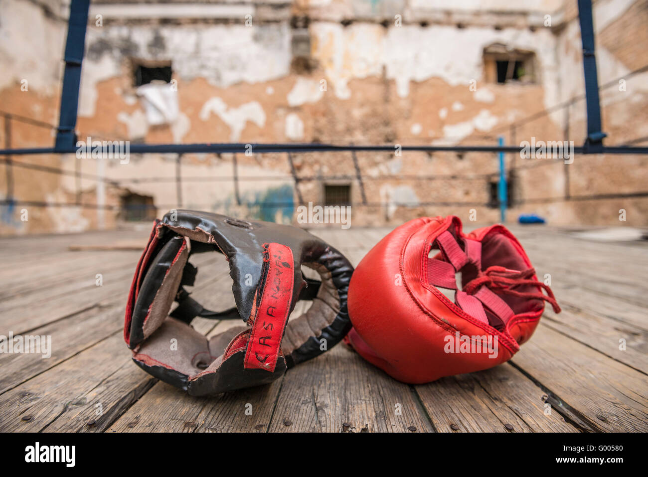 Two head protectors sit side-by-side on the makeshift wooden boxing ...