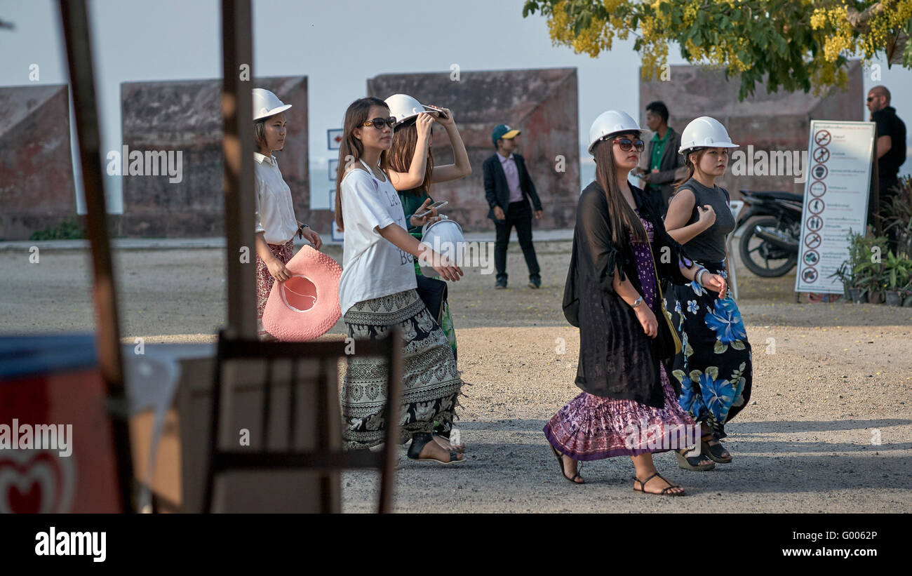 Japanese female tourists wearing mandatory hard hats at the Sanctuary ...
