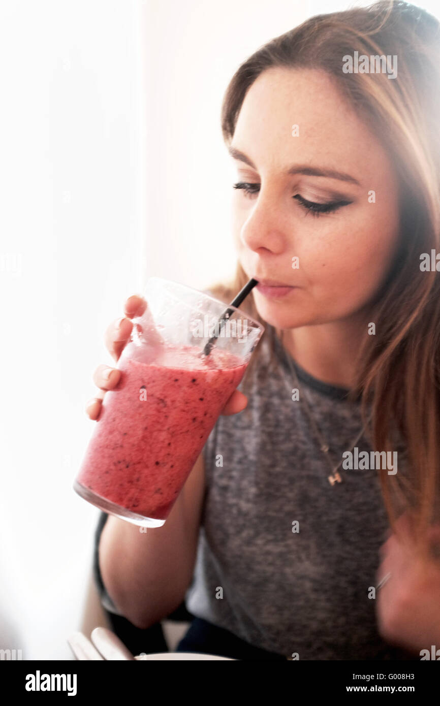 Young woman drinking a healthy Berry Smoothie drink Stock Photo - Alamy