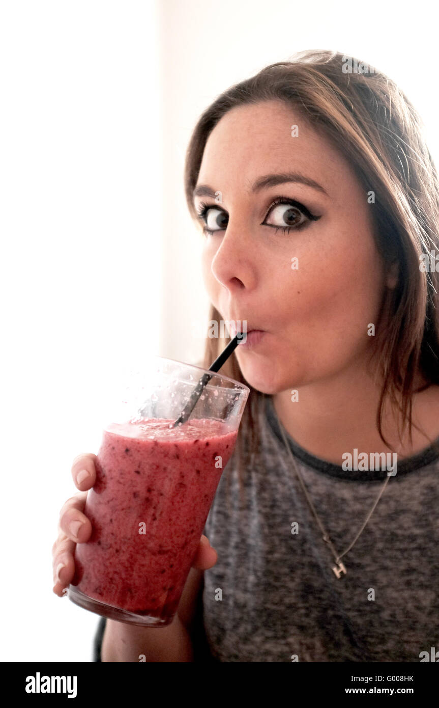 Young woman drinking a healthy Berry Smoothie drink Stock Photo - Alamy