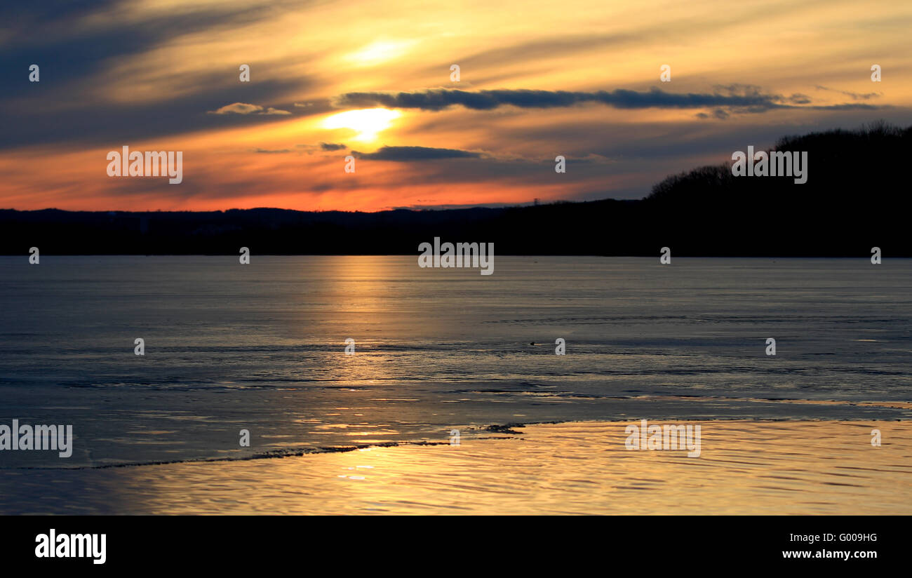 Beautiful photo of the amazing sunset on the icy lake Stock Photo - Alamy
