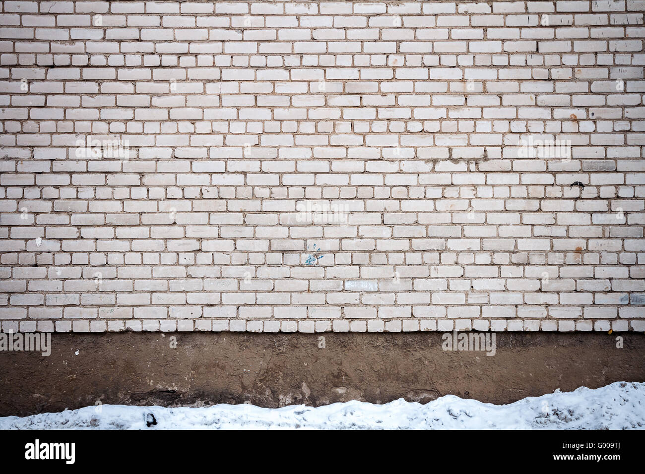 White brick wall and a ground covered with snow Stock Photo - Alamy