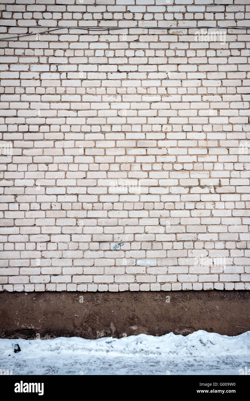 White brick wall and a ground covered with snow Stock Photo - Alamy