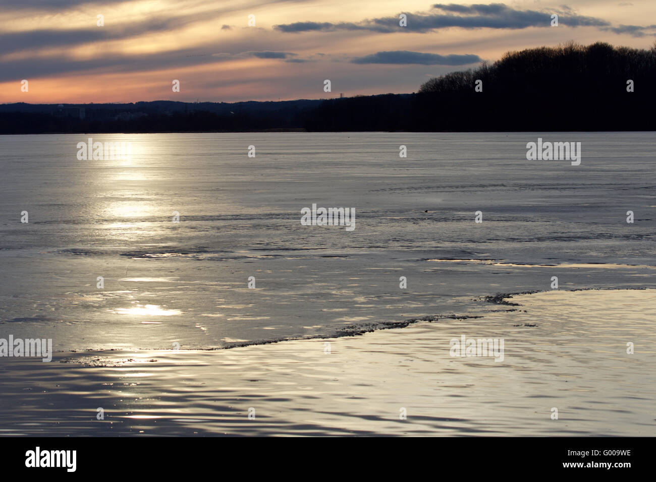 Image with a beautiful sunset on the icy lake and the forest Stock ...