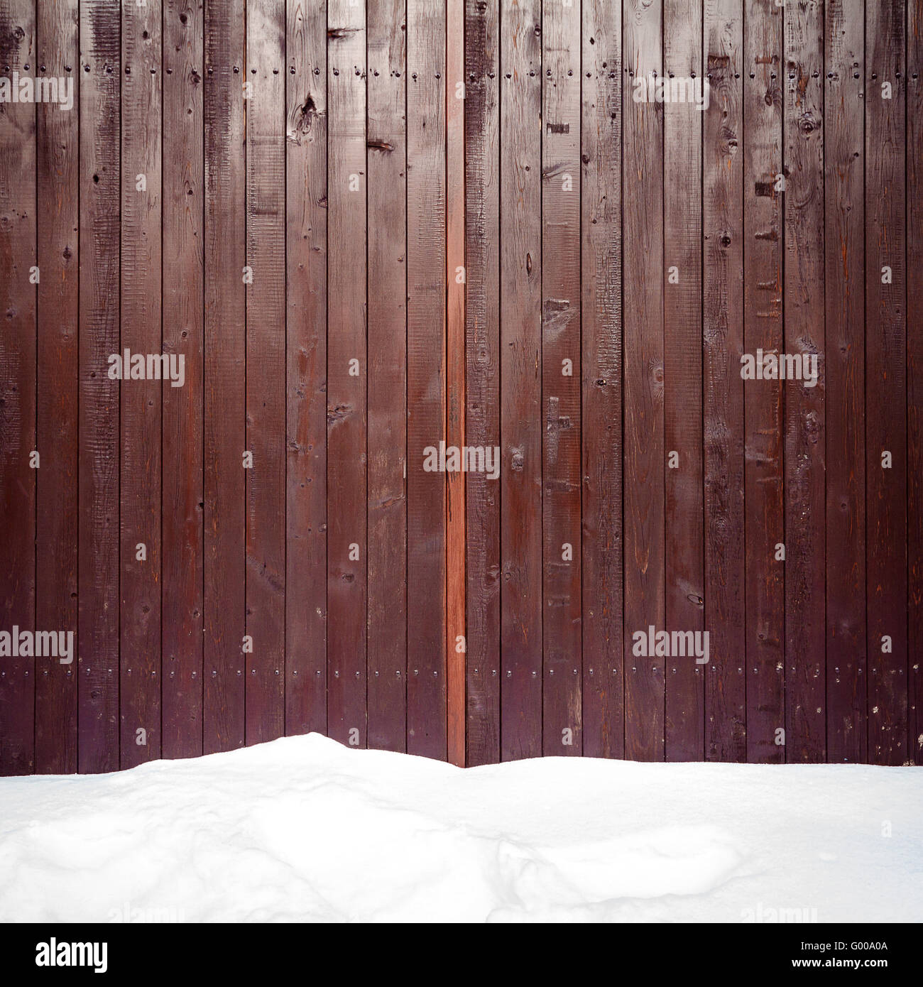 Old weathered wood plank fence and a ground covered with snow Stock ...