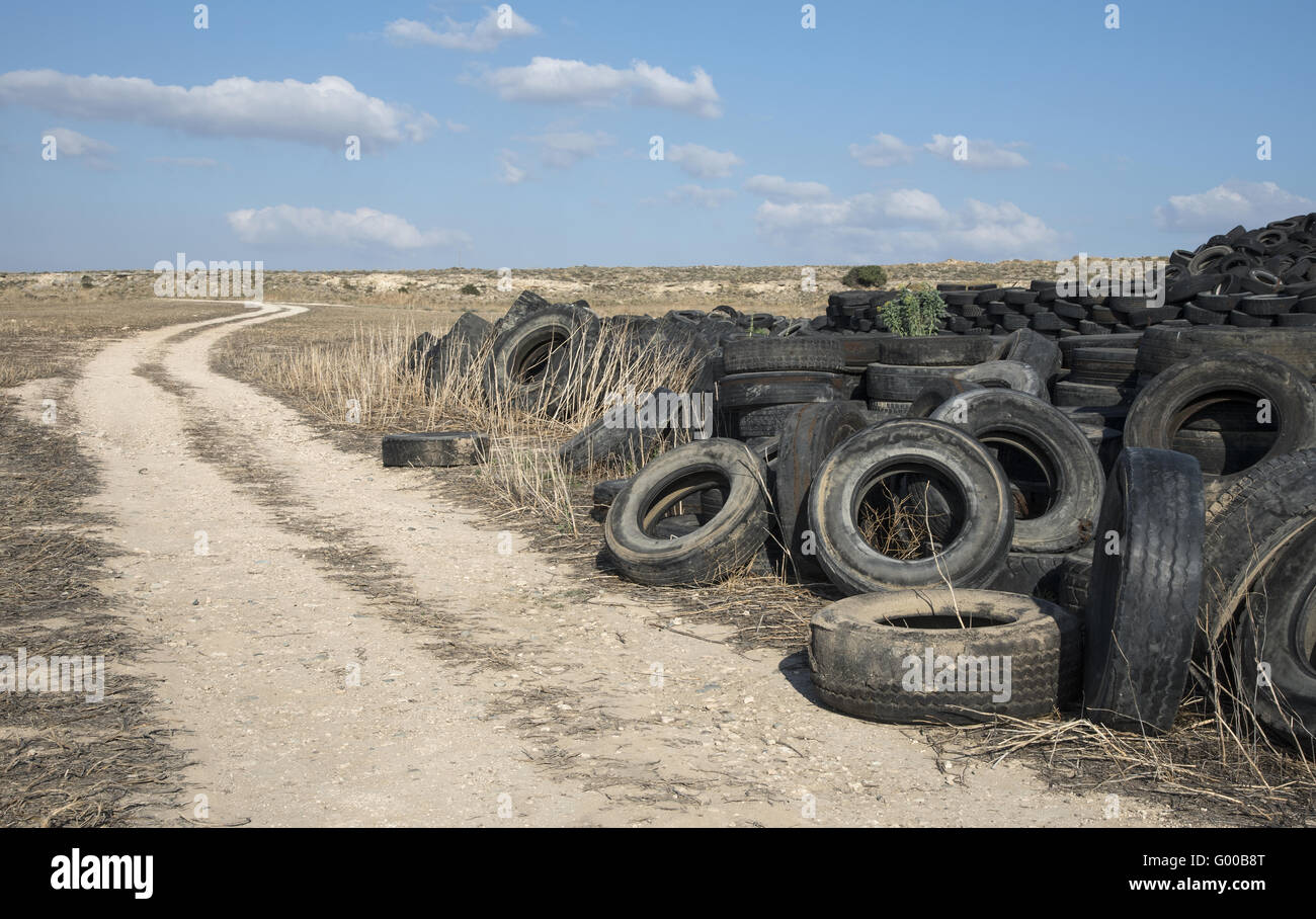 Old used rubber tires piled in a recycling yard waiting to be shredded ...