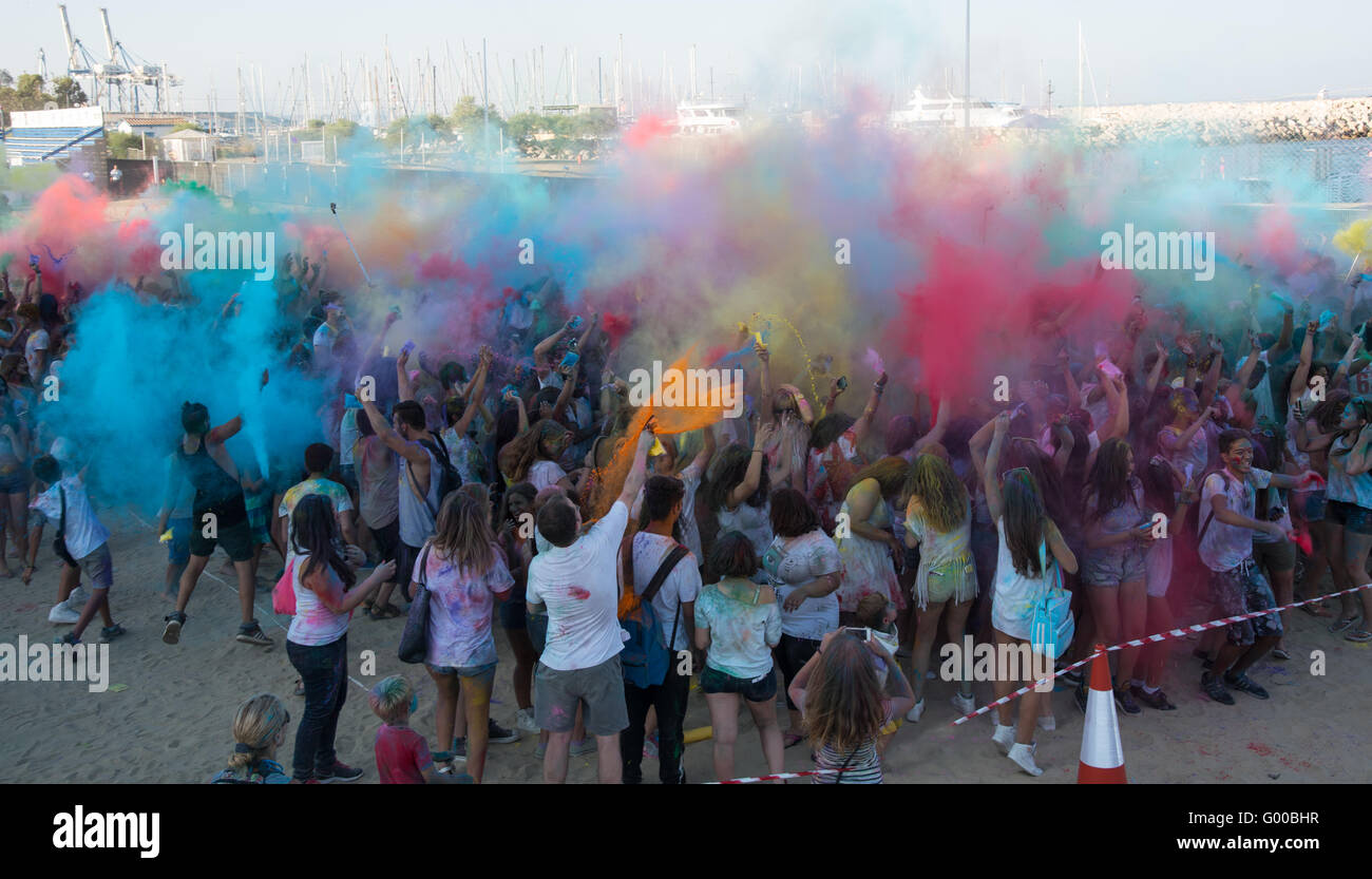 People with colored faces and bodies dancing and enjoying the Color War ...