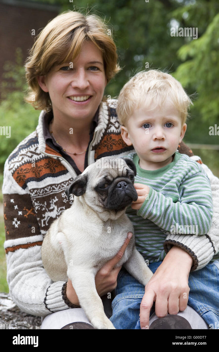 Woman with child and pug Stock Photo - Alamy