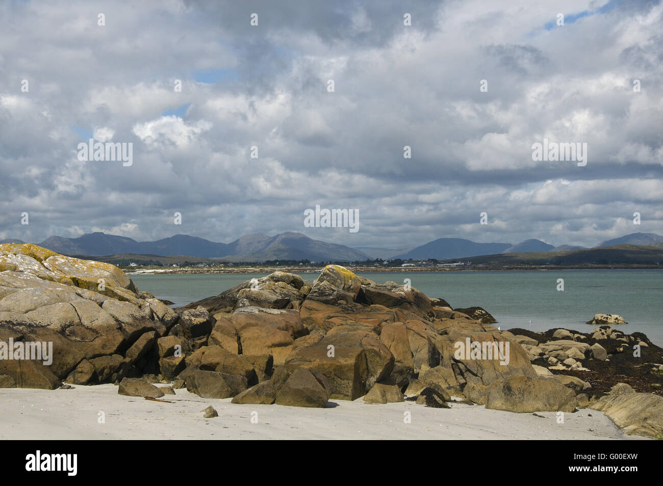 Sandy beach with rocks Stock Photo - Alamy