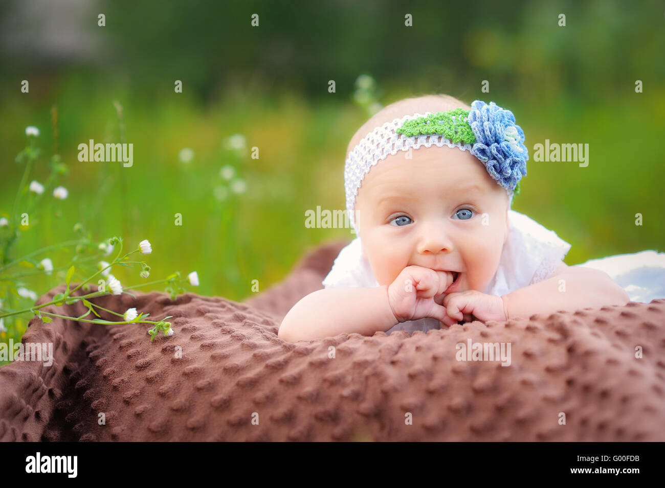 Cute little girl on the meadow in summer day Stock Photo - Alamy