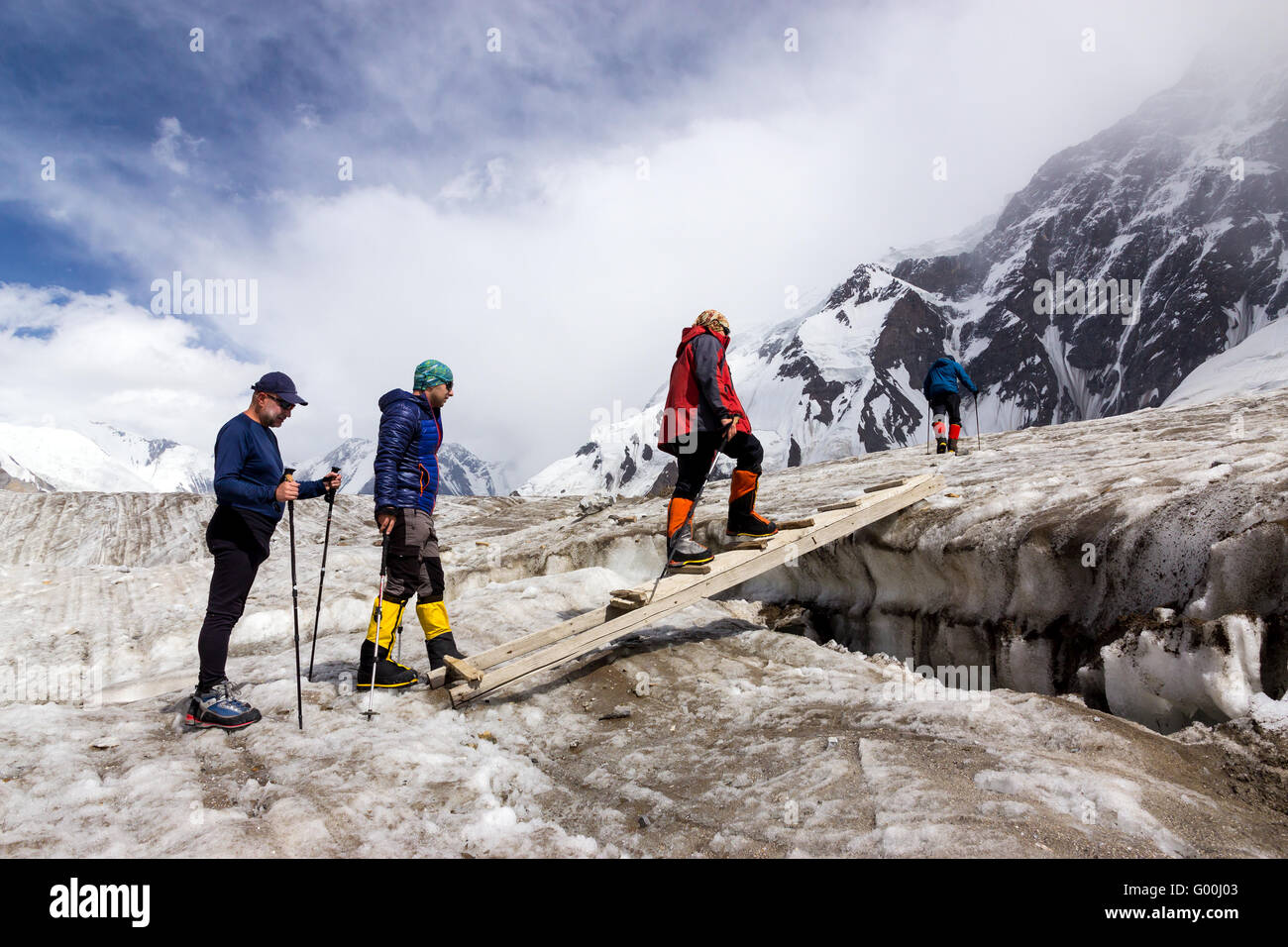 People Crossing Glacier Crevasse on Wood Shaky Footbridge Stock Photo ...