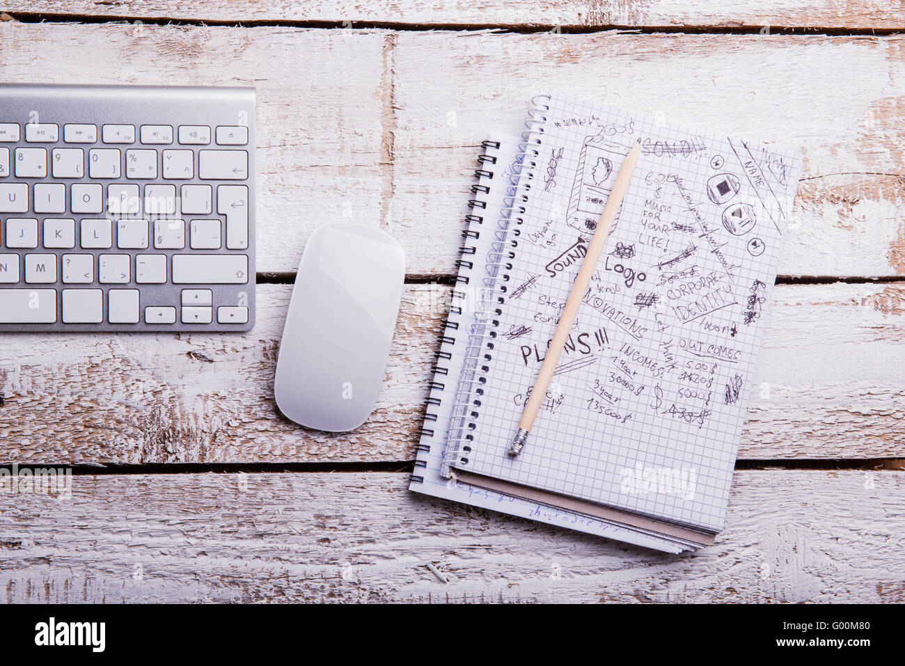 Computer keyboard, mouse and notepads around the workplace. Flat lay ...