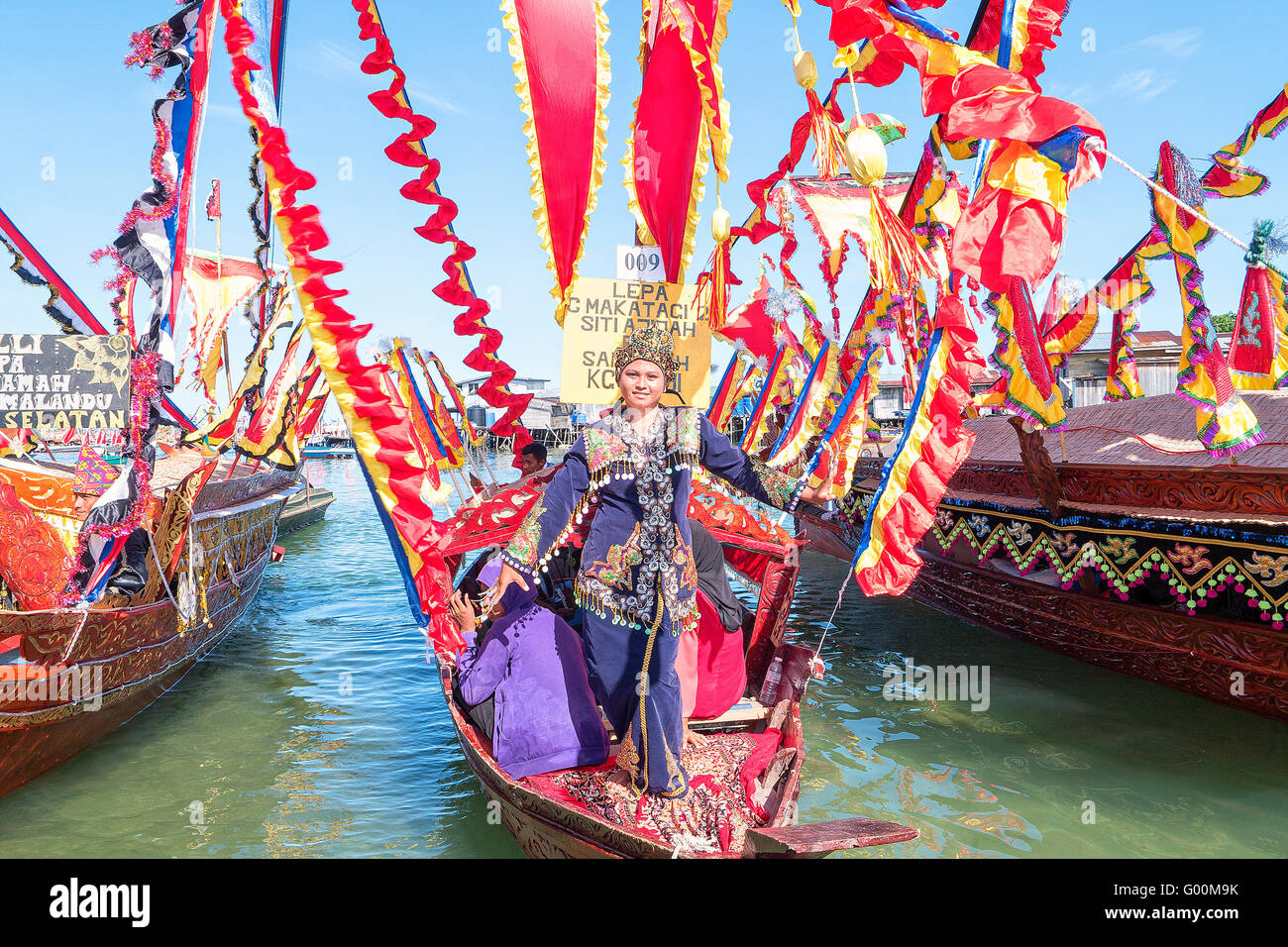 Bajau lady dancing on traditional boat called Lepa Lepa decorated with ...