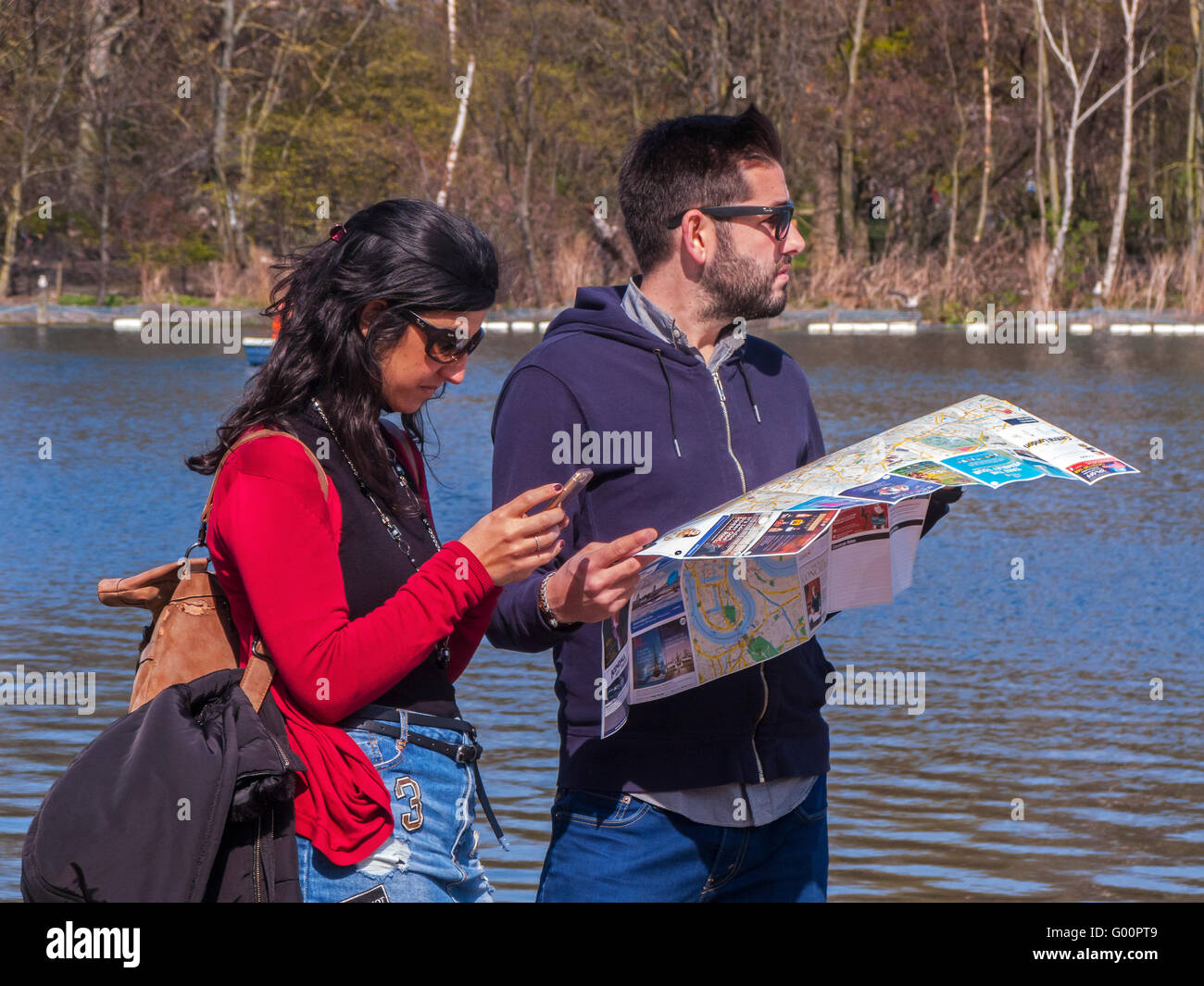 Young Couple, tourists, checking map and smart phone, The Serpentine ...