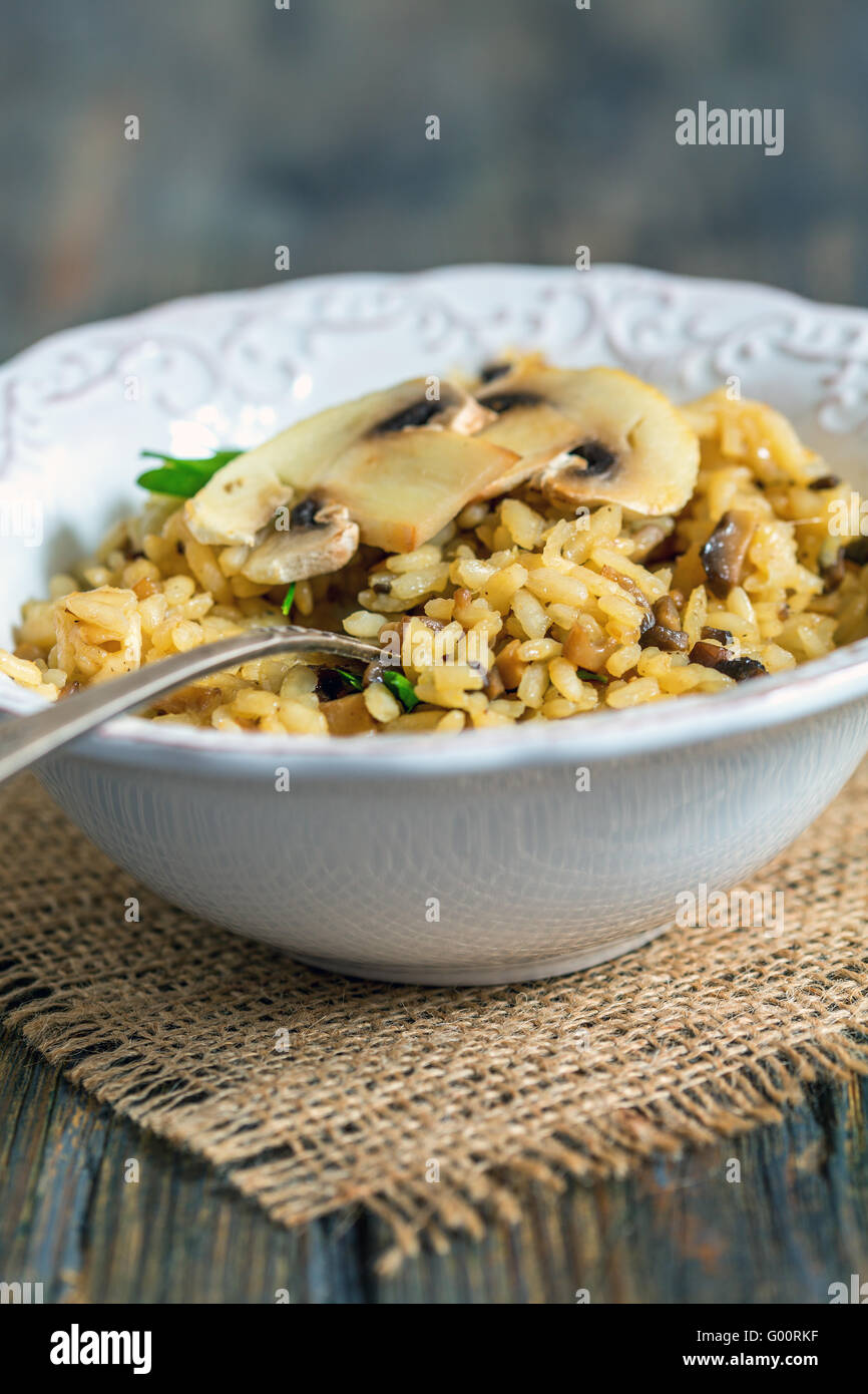 White plate with mushroom risotto Stock Photo - Alamy