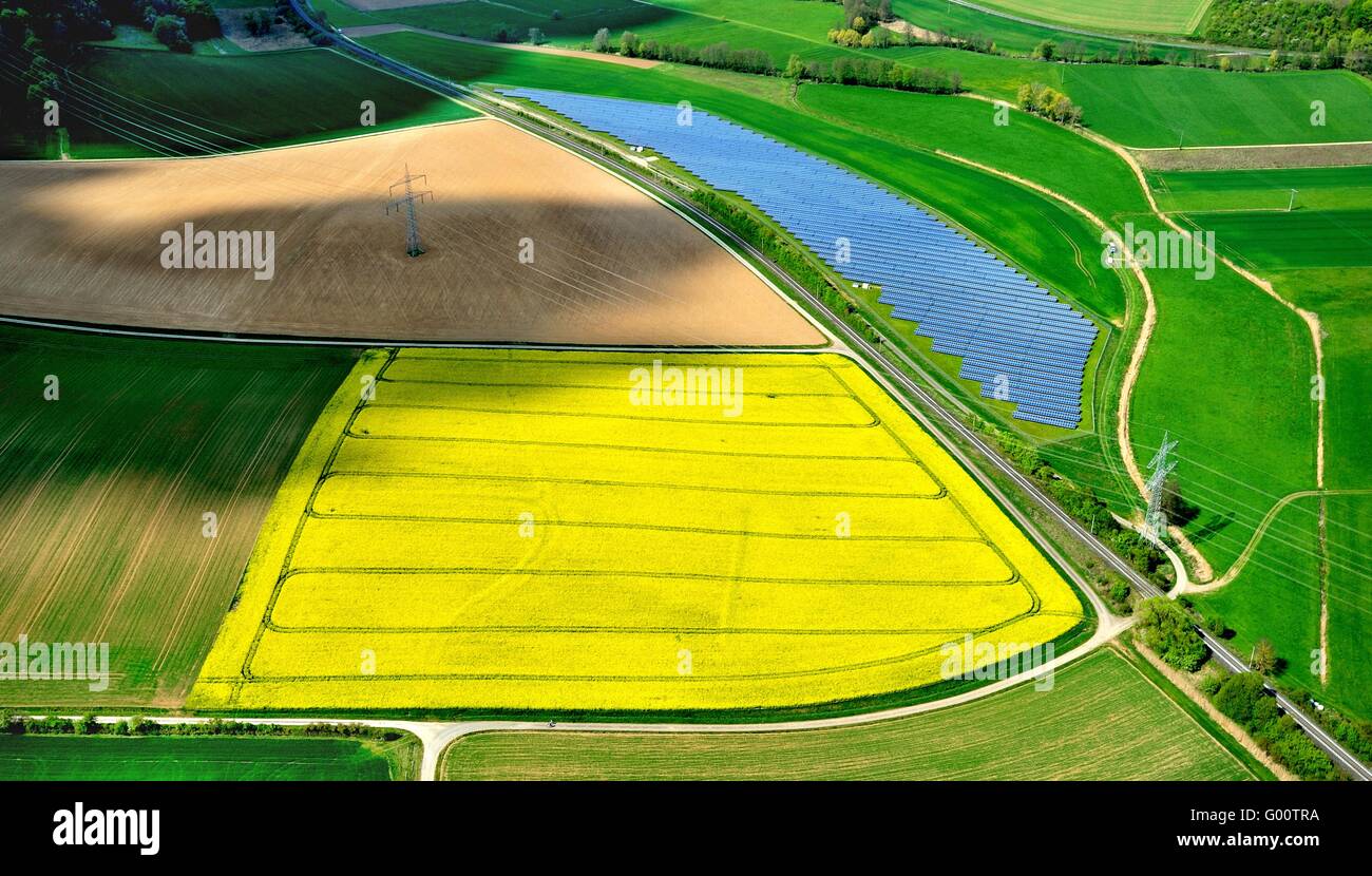 Rape field with solar system Stock Photo - Alamy