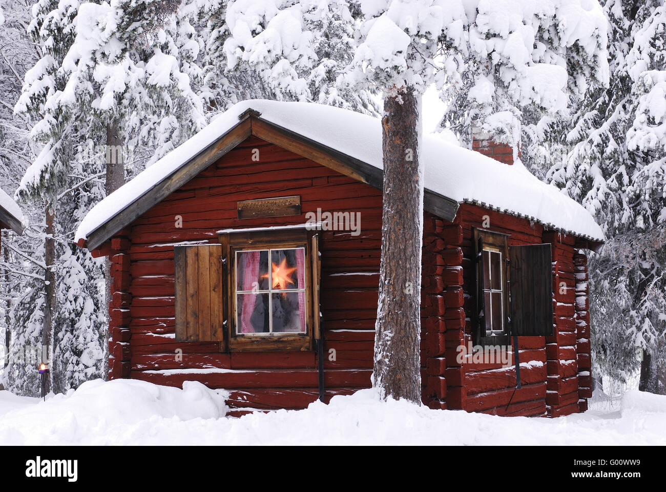 Cabin in snowy forest Stock Photo - Alamy