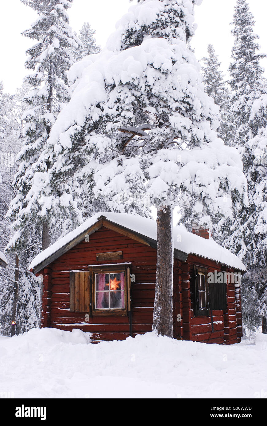 Cabin in snowy forest Stock Photo - Alamy