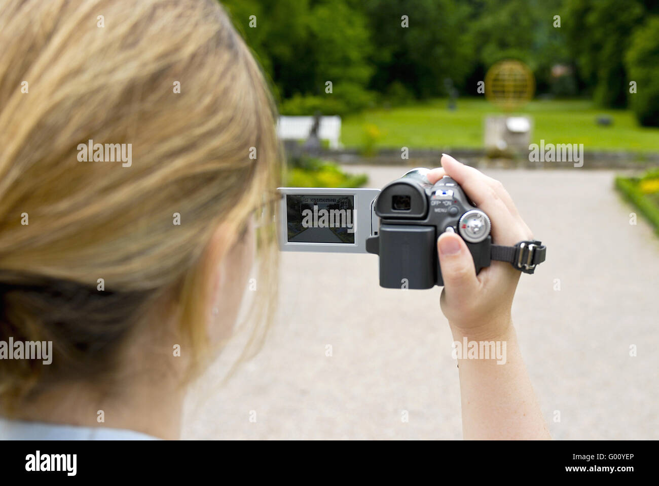 Young woman with a video camera while filming Stock Photo - Alamy