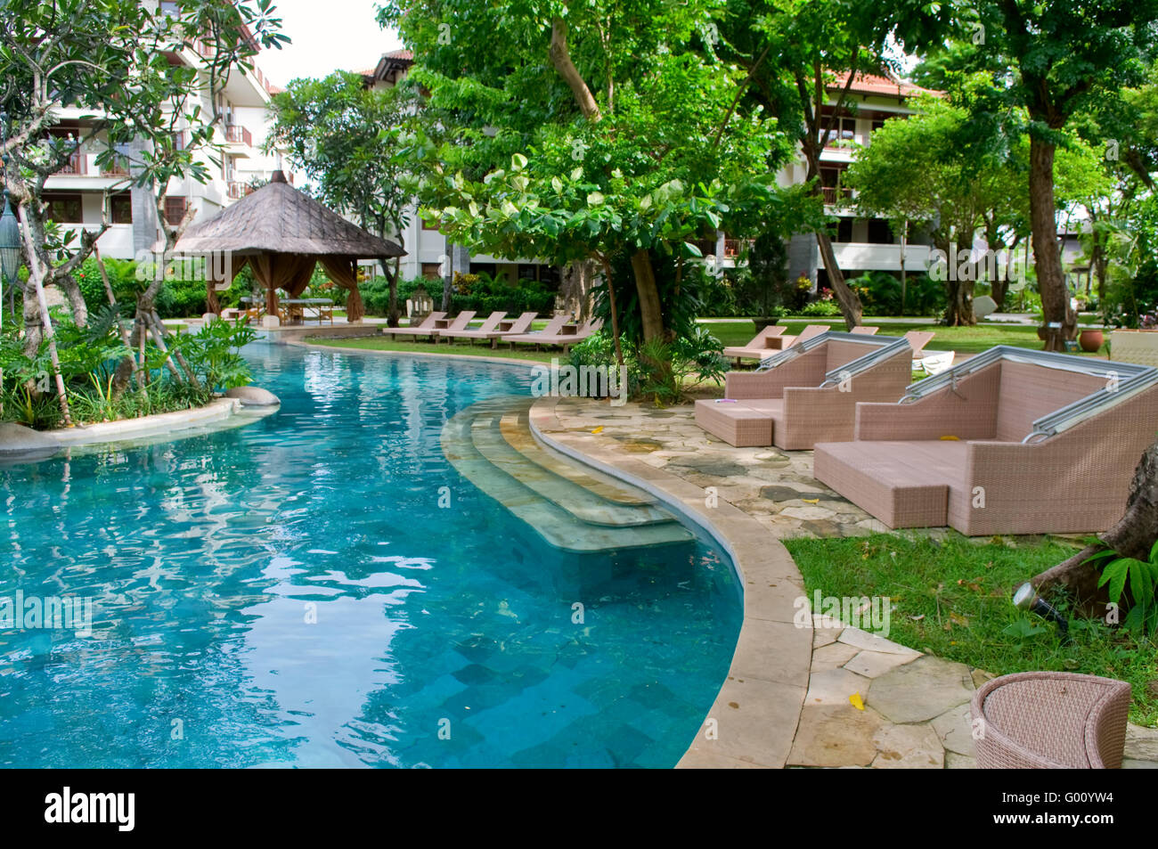 View of tropical resort swimming pool scene in morning Stock Photo - Alamy