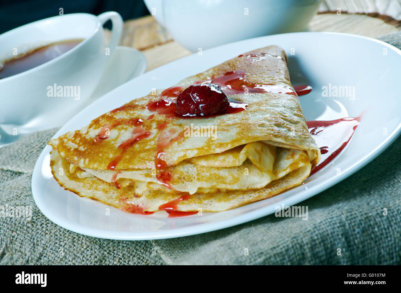 The traditional Russian breakfast - Homemade crepes with jam and tea ...