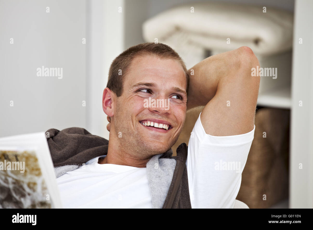 smiling young man reading a book Stock Photo - Alamy