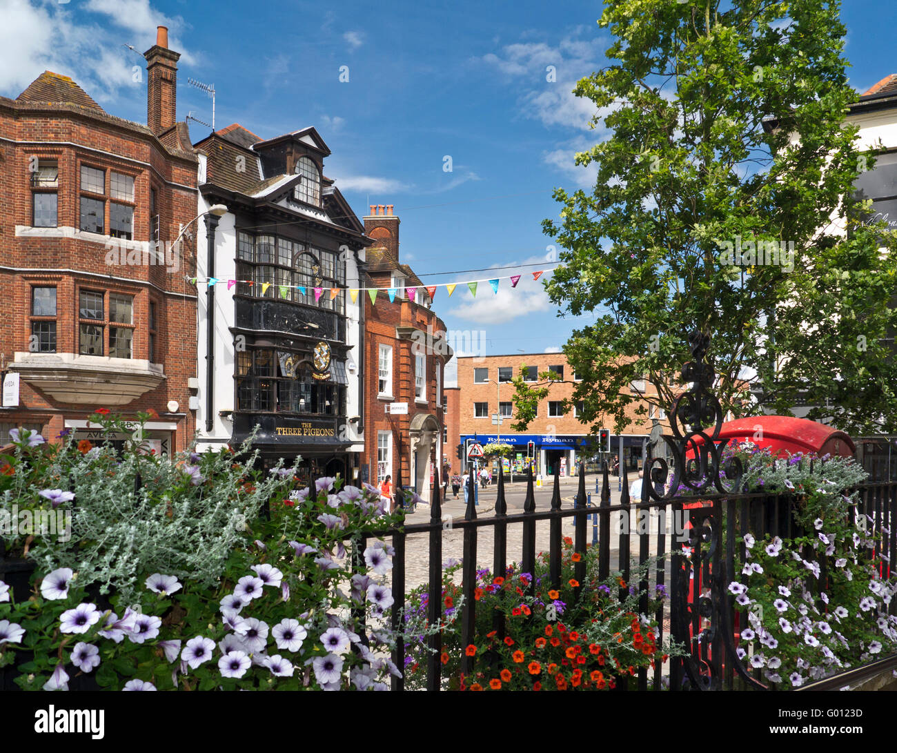 Guildford High Street with petunias and traditional red telephone box ...