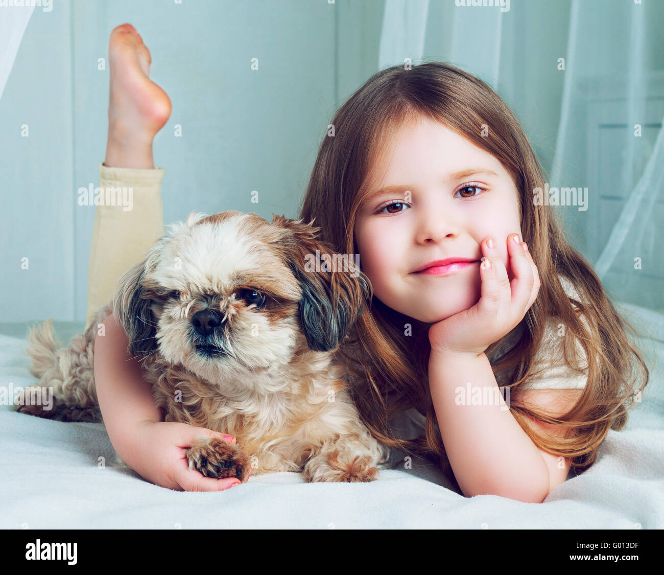happy girl and her dog in bed at home Stock Photo - Alamy