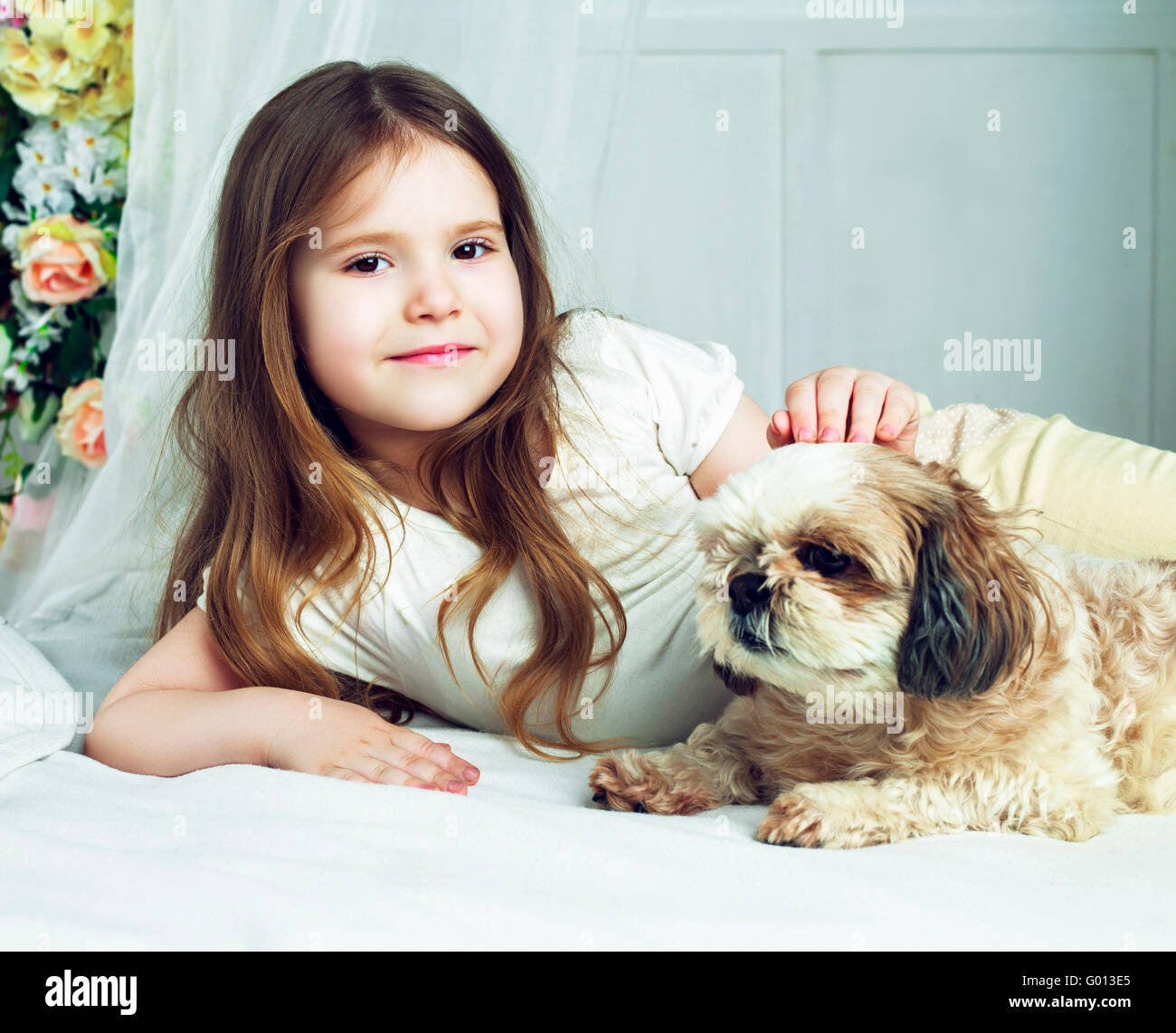 happy girl and her dog in bed at home Stock Photo - Alamy
