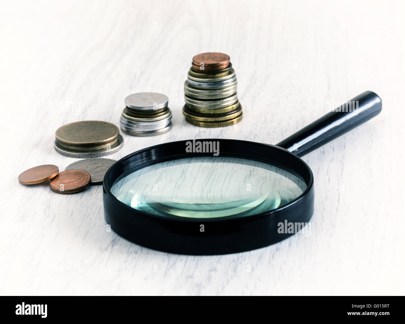 coins and magnifying glass, close-up Stock Photo - Alamy