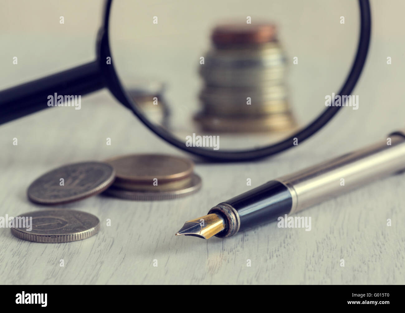pen, coins and a magnifying glass, retro Stock Photo - Alamy
