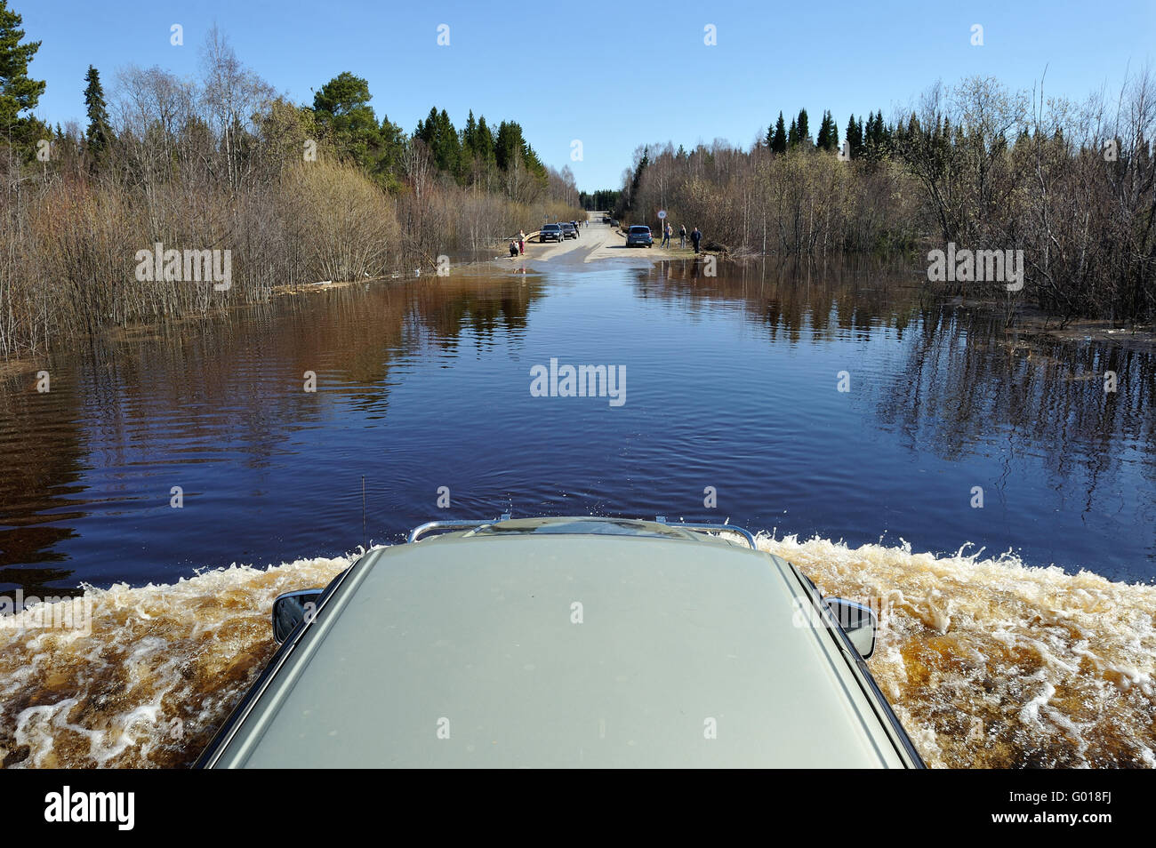 Overcoming road section with a flooded river by car SUV Stock Photo - Alamy
