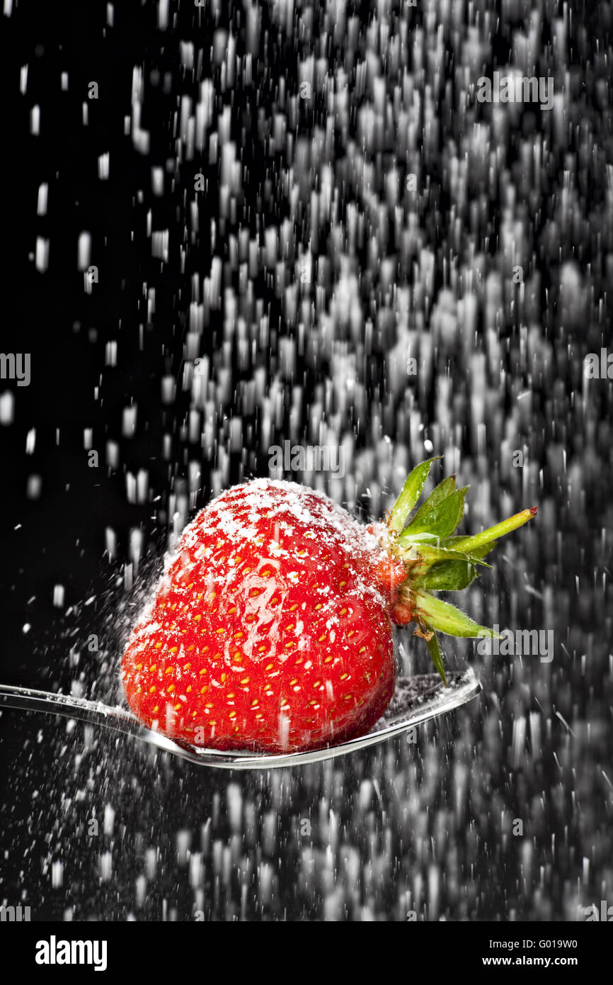 icing sugar falling on a strawberry on a spoon Stock Photo - Alamy