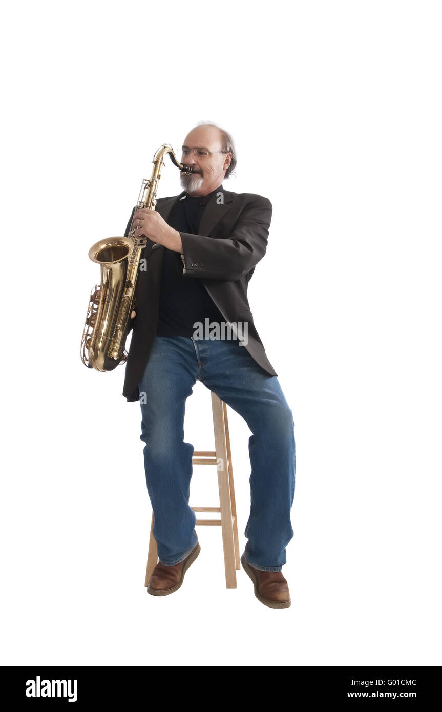 Playing a tenor sax seated on a stool Stock Photo - Alamy