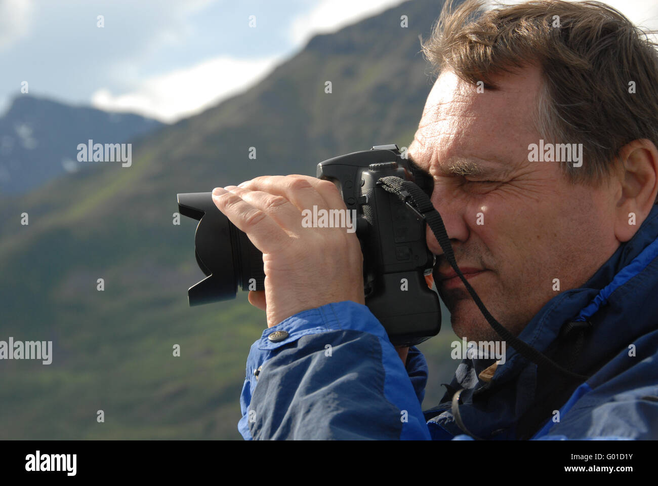 Man taking pictures with camera Stock Photo - Alamy