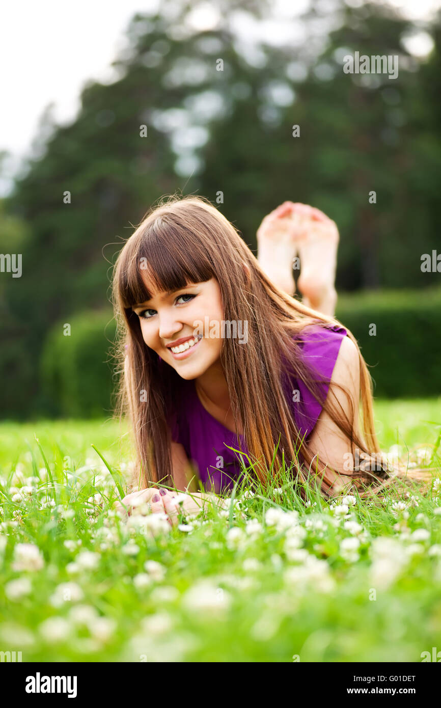 Lying pretty smiling girl with long brown hairs Stock Photo - Alamy