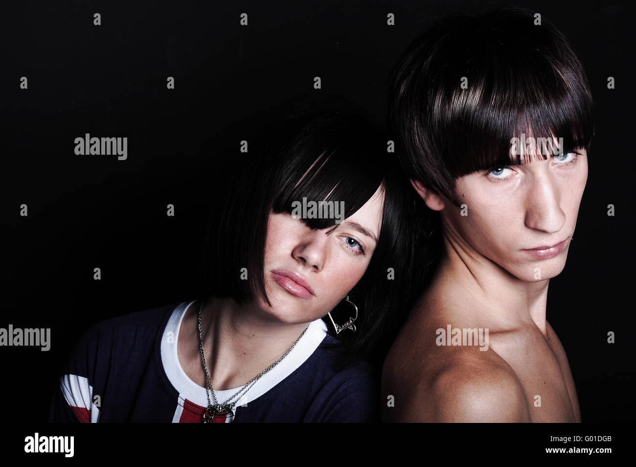 Cute young couple with fashion haircut, on black Stock Photo - Alamy
