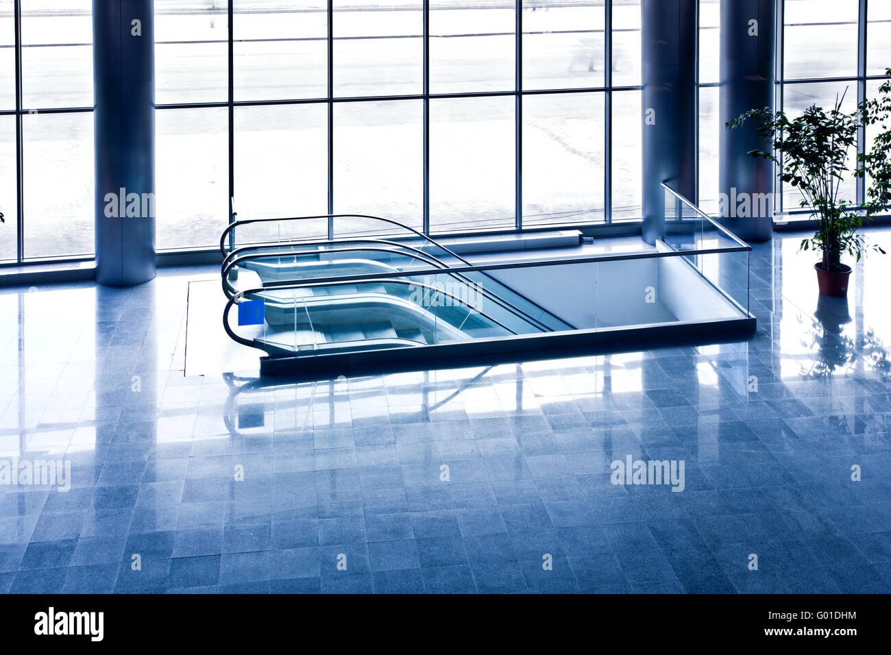 Gray escalator enter in corridor in office centre Stock Photo - Alamy