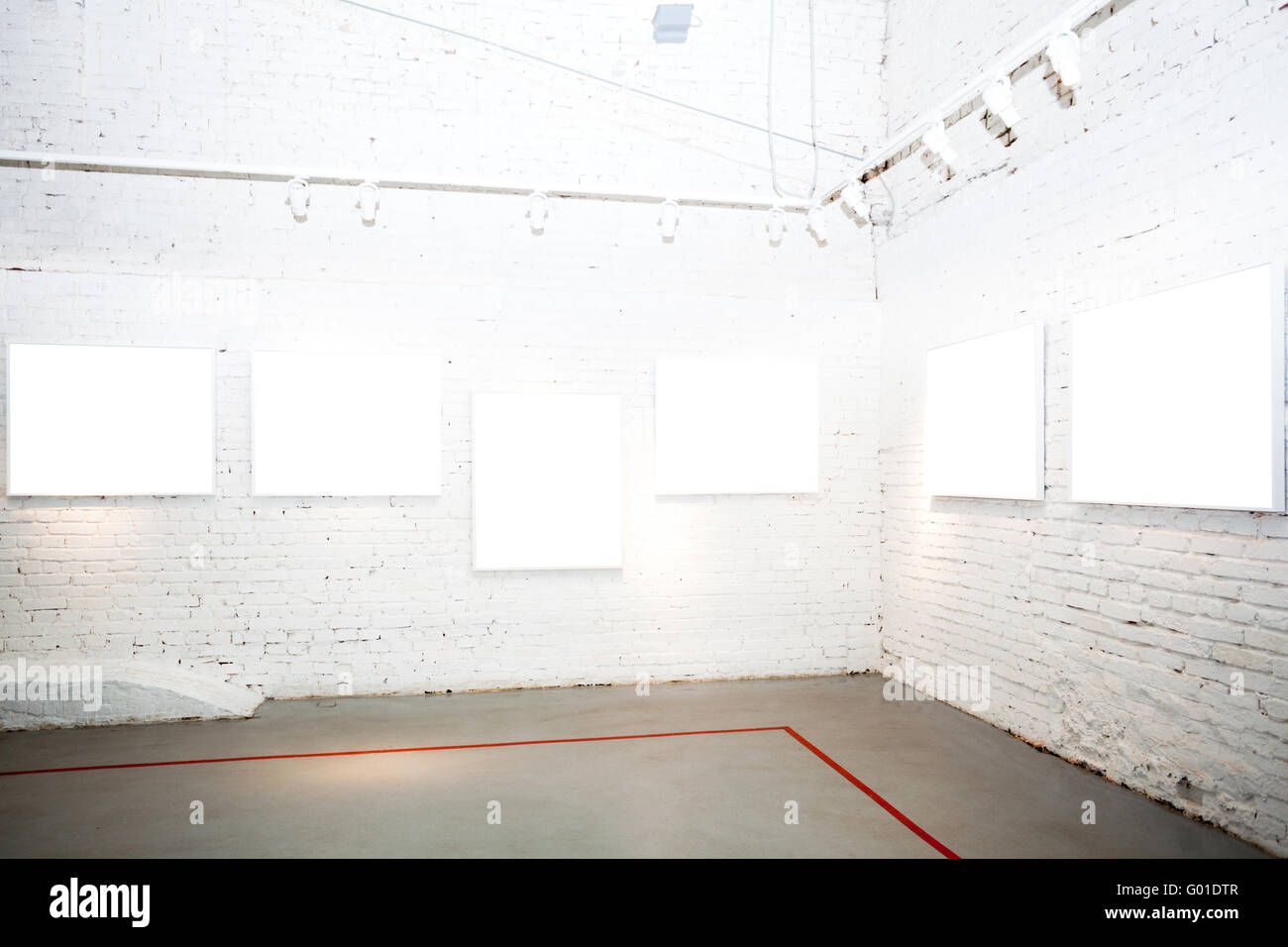 Brick white walls in museum with empty frames Stock Photo - Alamy