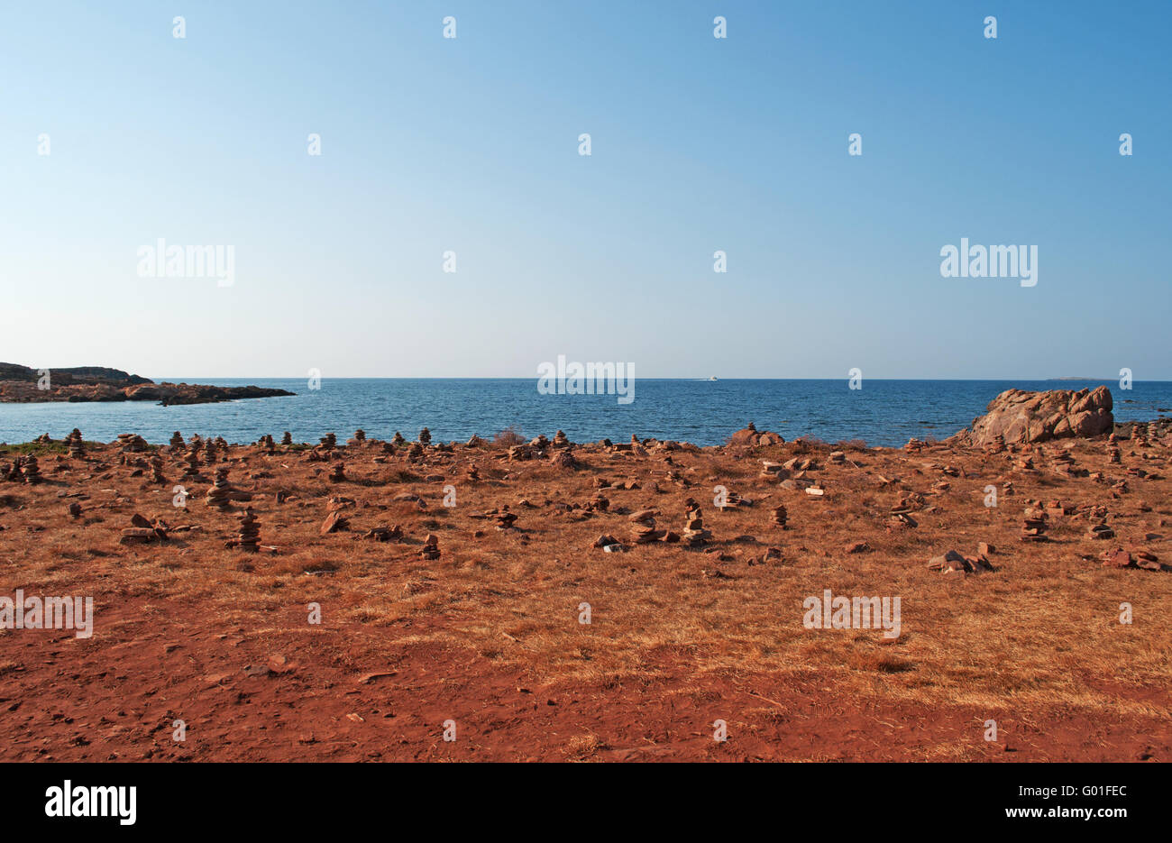Menorca: red sand on the path to Cala Pregonda, secluded cove with ...