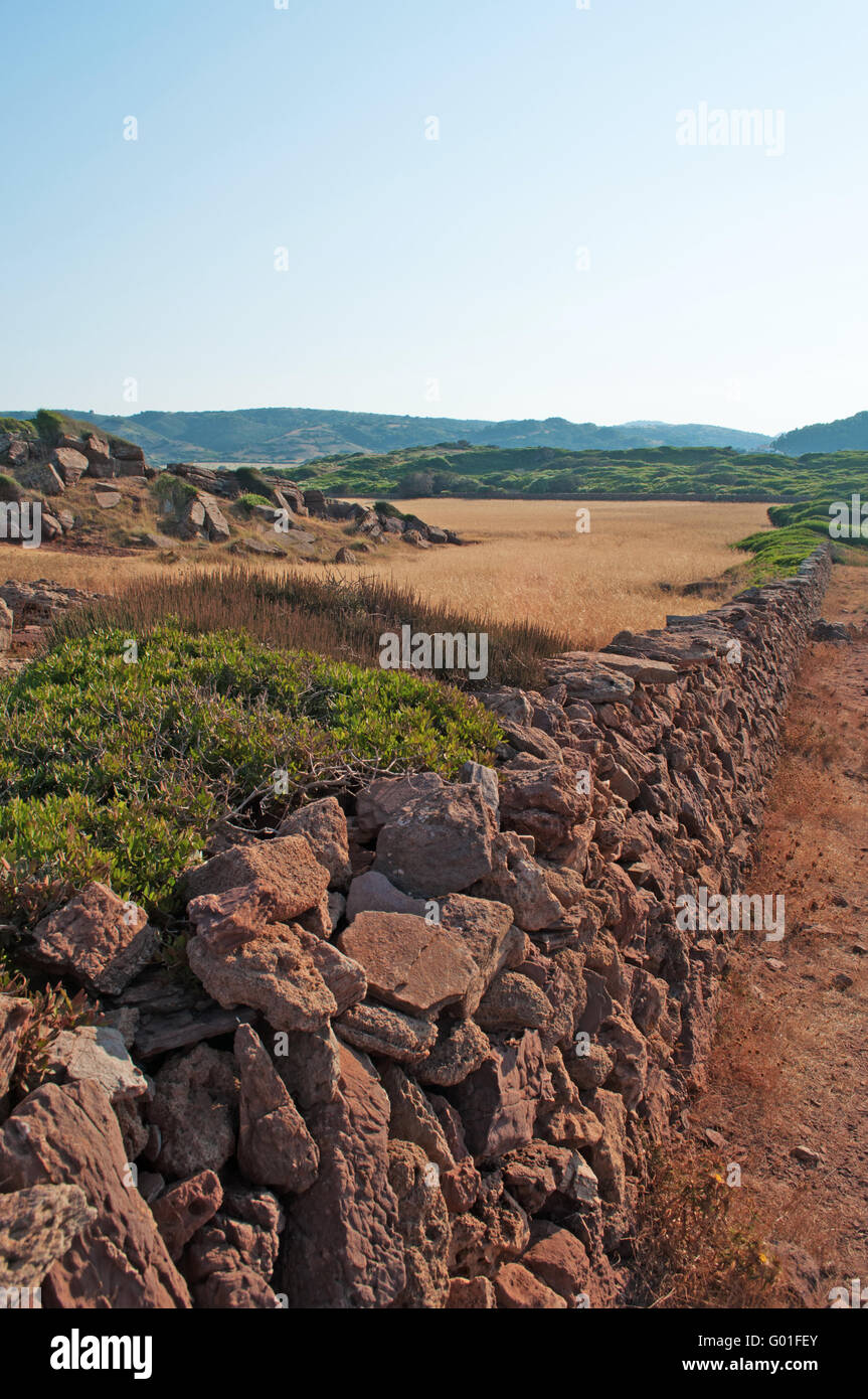 Menorca: red sand on the path to Cala Pregonda, secluded cove with ...